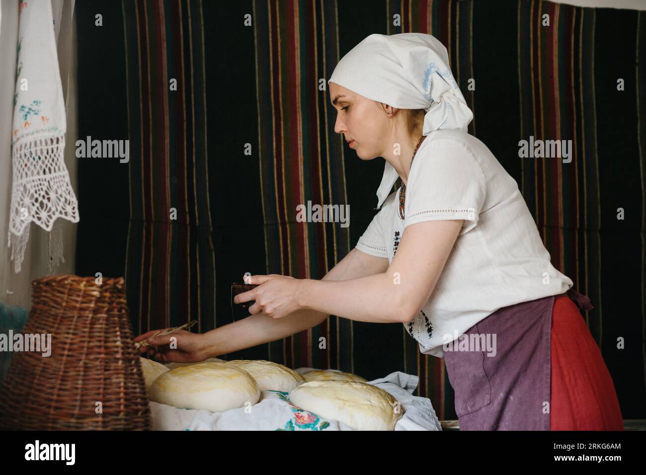 The process of baking traditional Ukrainian bread. A baker smears raw ...