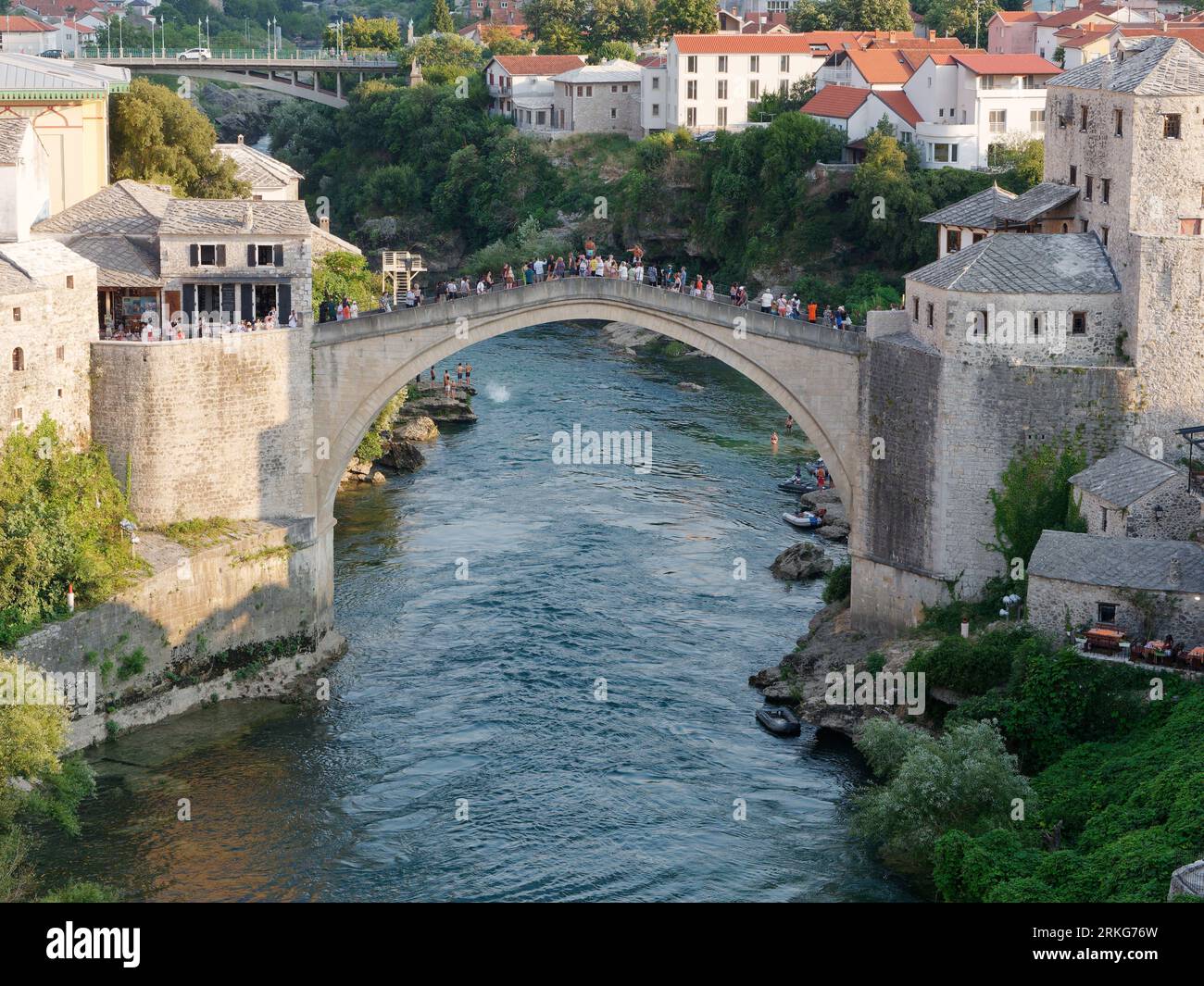 People sightseeing from Stari Most (Old Bridge) over the Neretva River ...