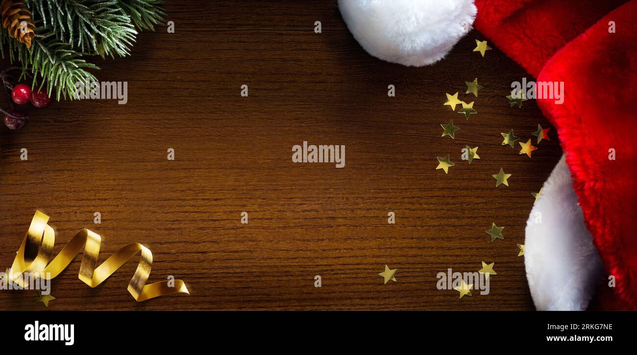 Christmas banner. Christmas tree branch and Santa hat on wooden ...