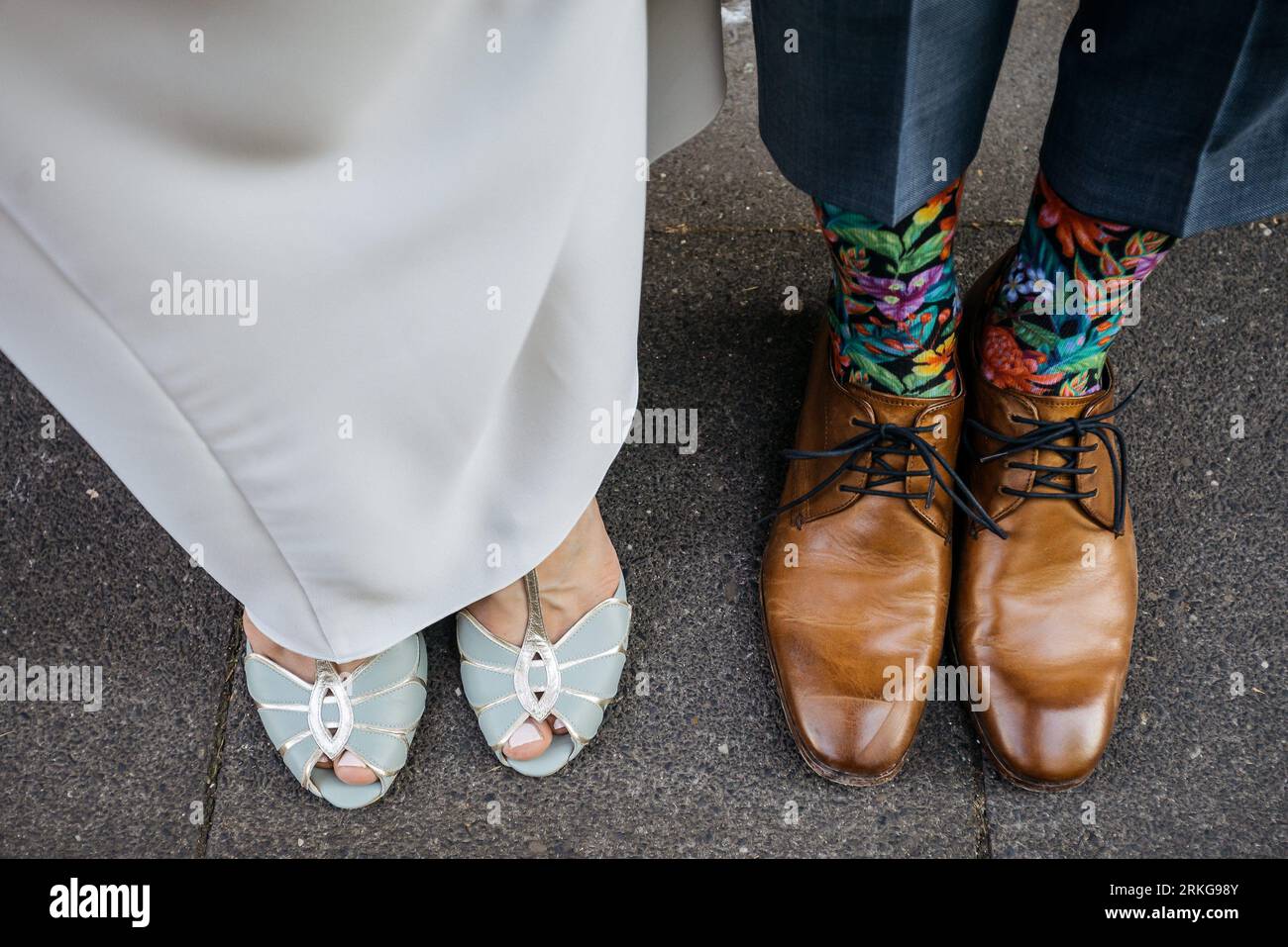 Two people standing side-by-side, wearing matching shoes and socks ...