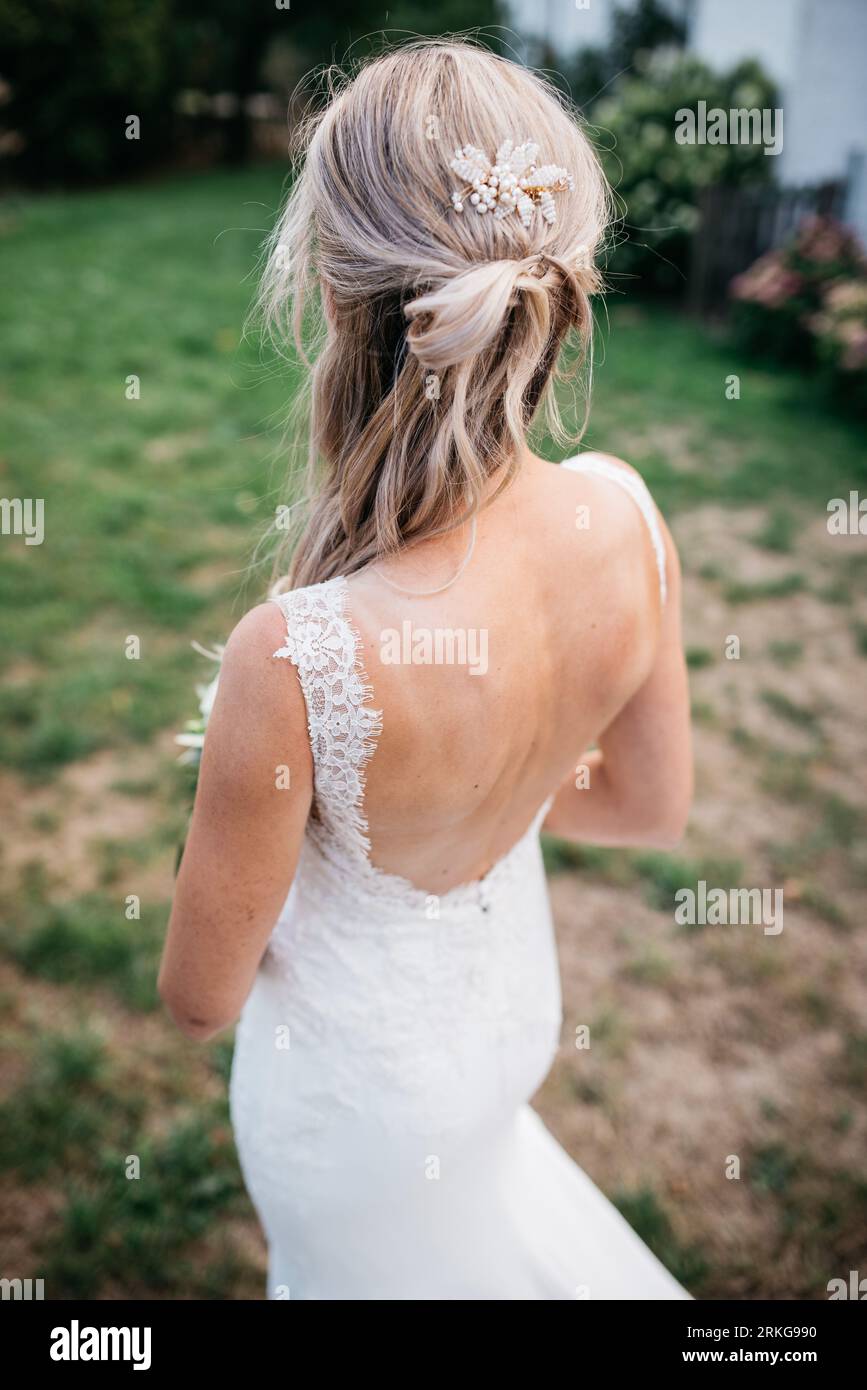 An attractive young bride wearing a beautiful white wedding dress ...