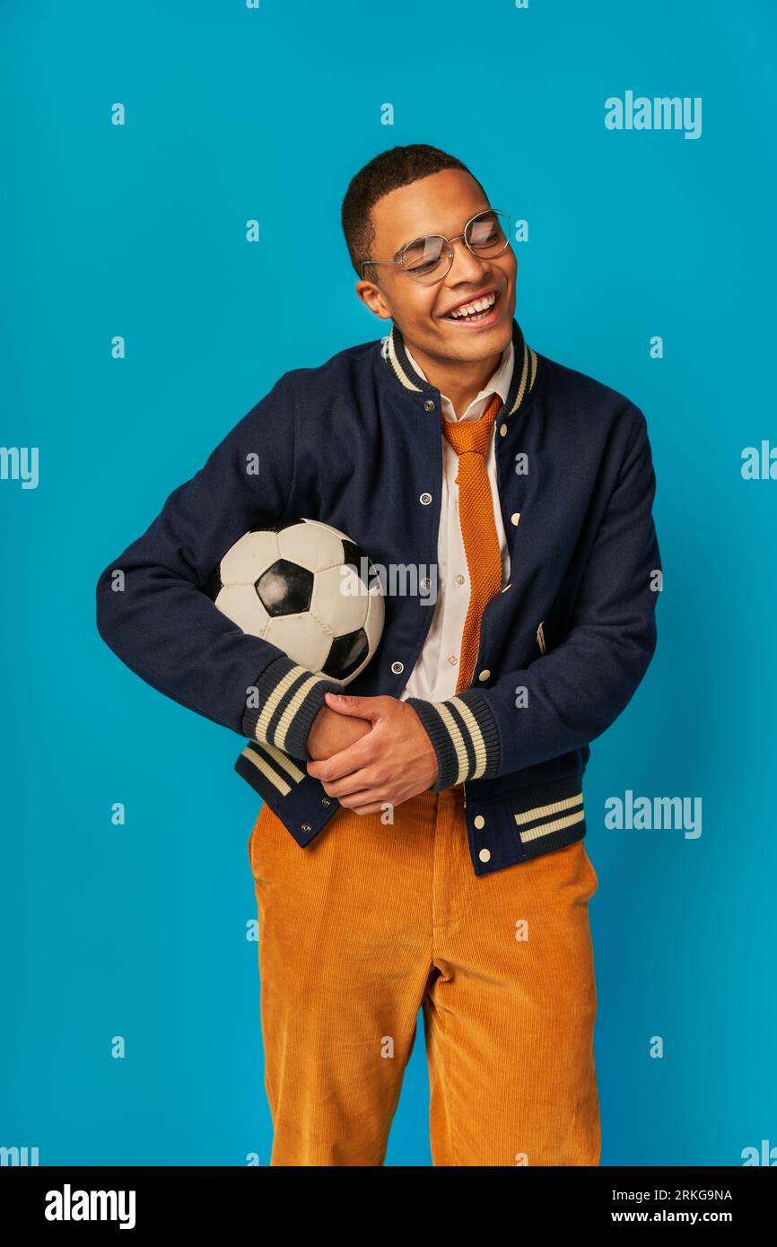 happy african american student in stylish jacket and orange pants ...