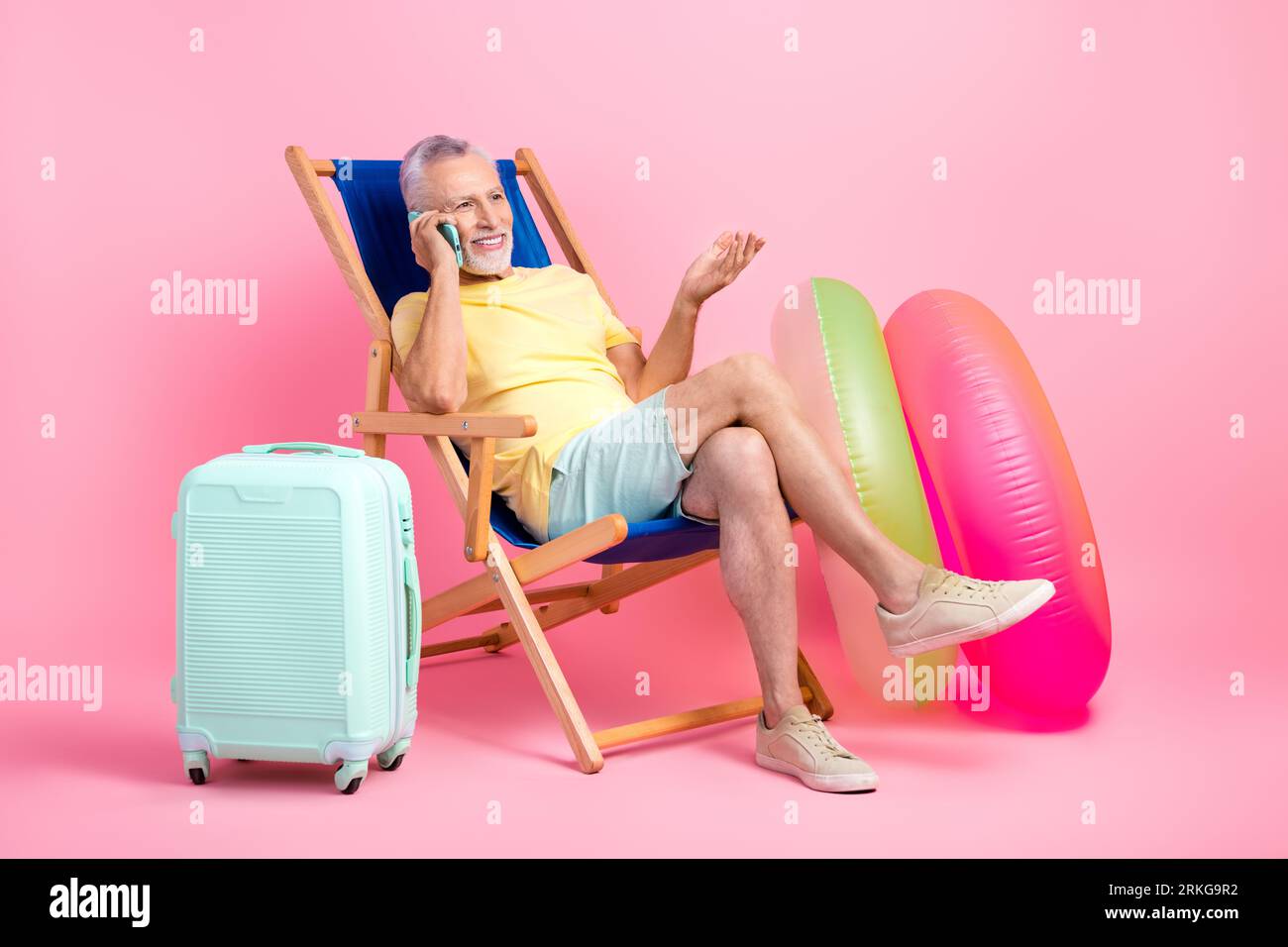 Full body photo of pensioner man sitting his sunbed talking ...