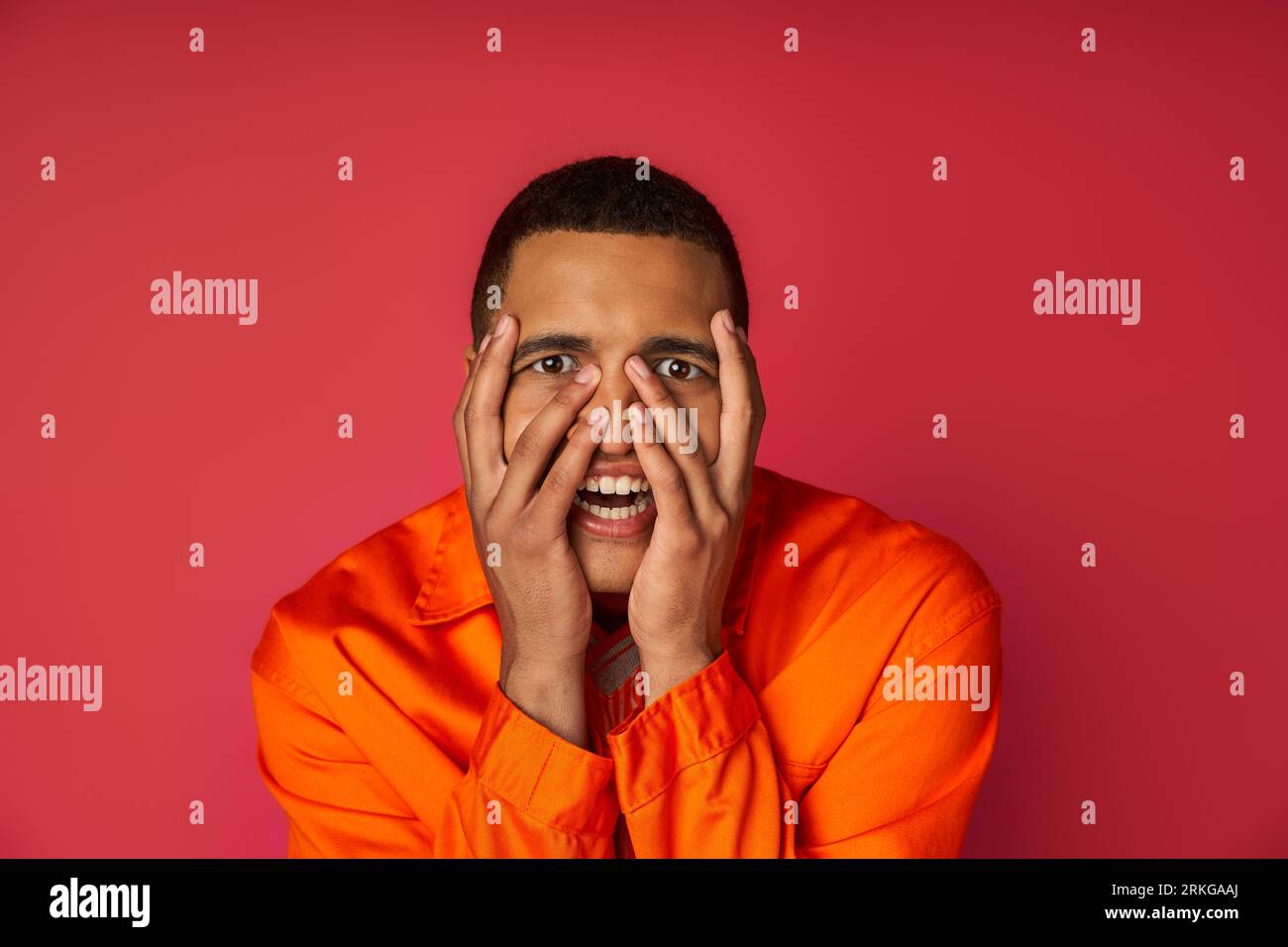 shocked and nervous african american man looking at camera and ...