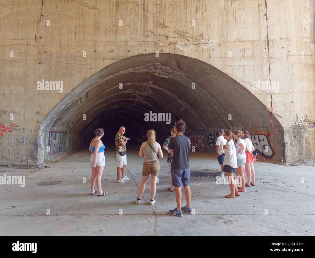 Tour group explore an old secret underground bunker used by Yugoslav ...