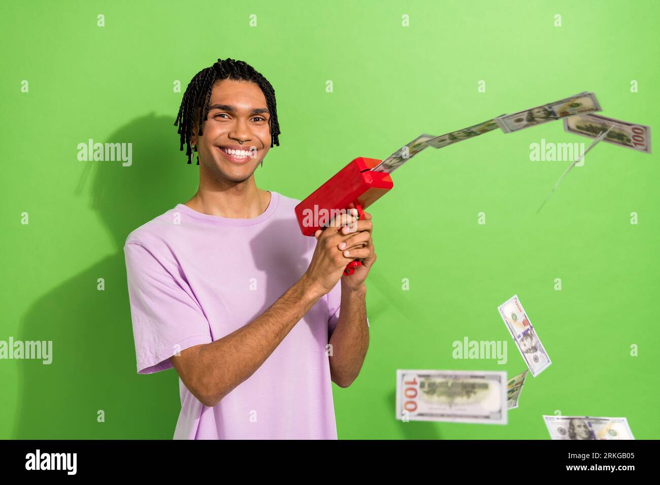Portrait of cheerful successful person beaming smile hold money gun ...