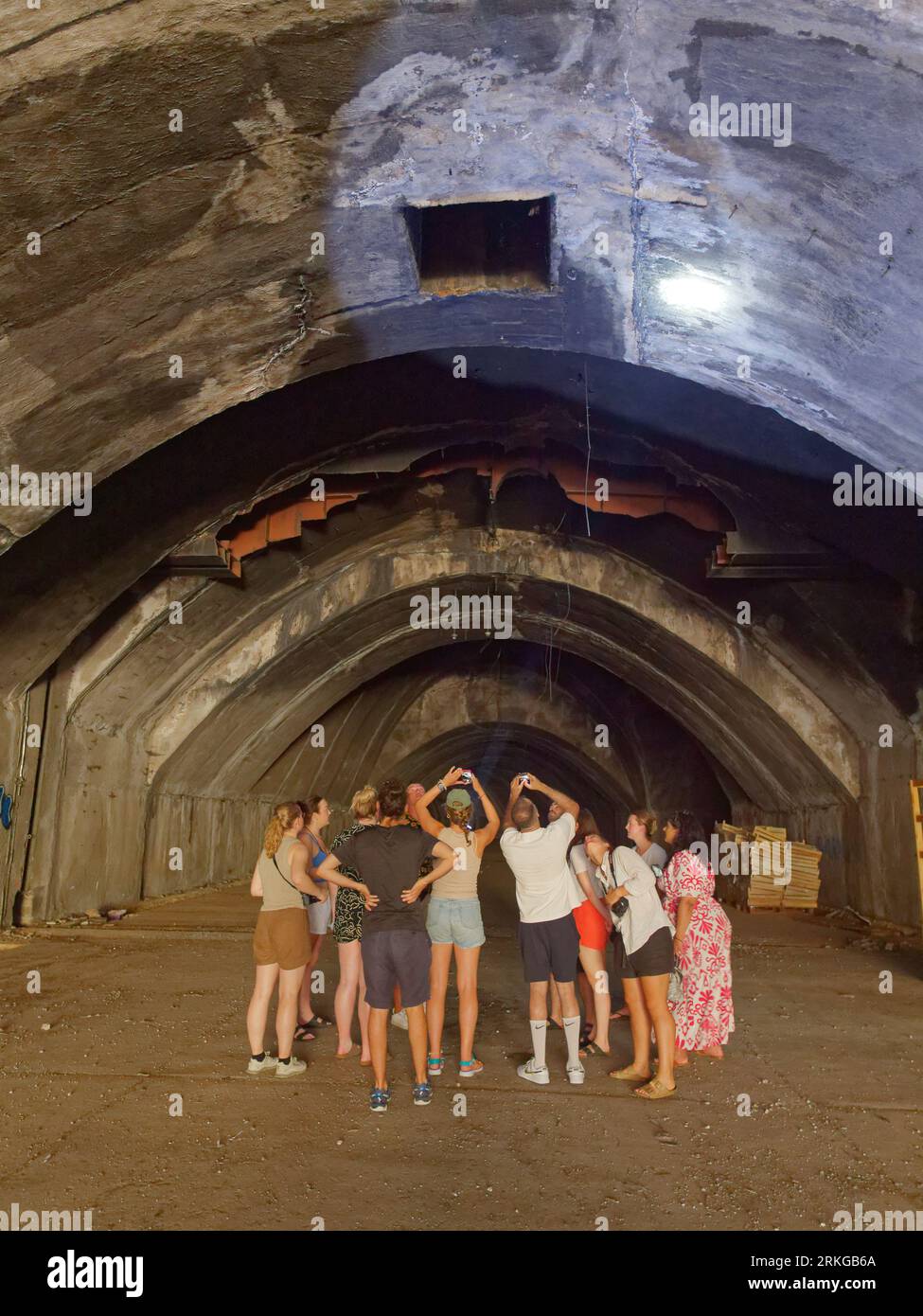 Tour group explore an old secret underground bunker used by Yugoslav ...