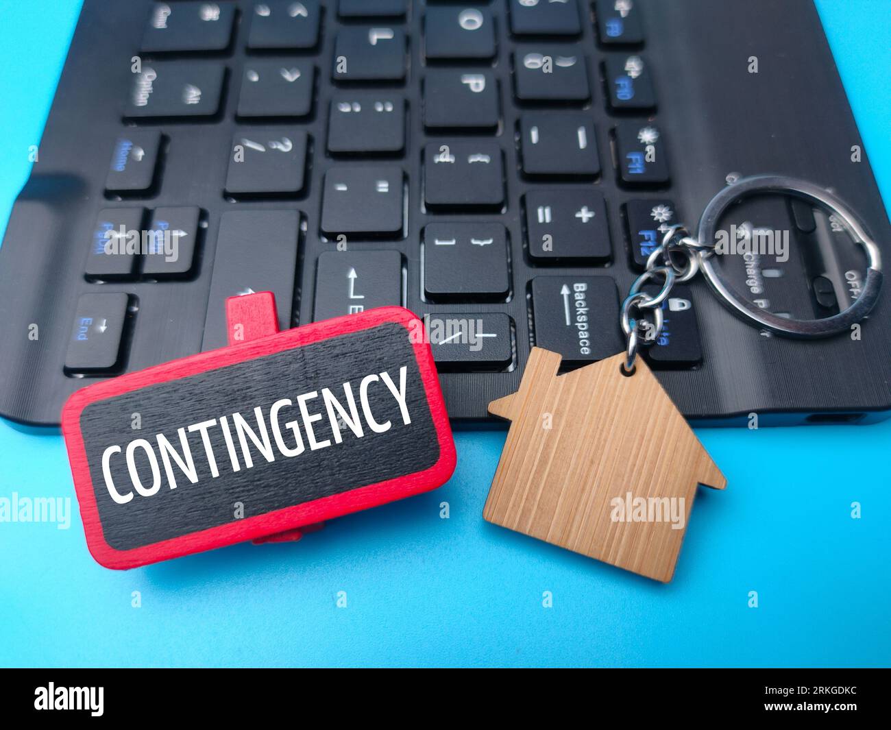A sign with the word 'contingency' on a black keyboard background Stock ...