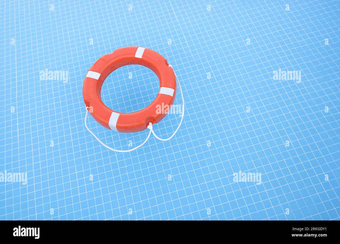 Orange lifebuoy lying on water in swimming pool closeup Stock Photo - Alamy