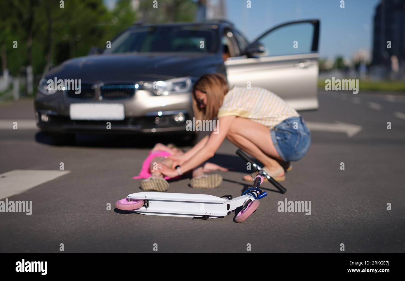Child scooter lying in front of little girl injured in car accident ...