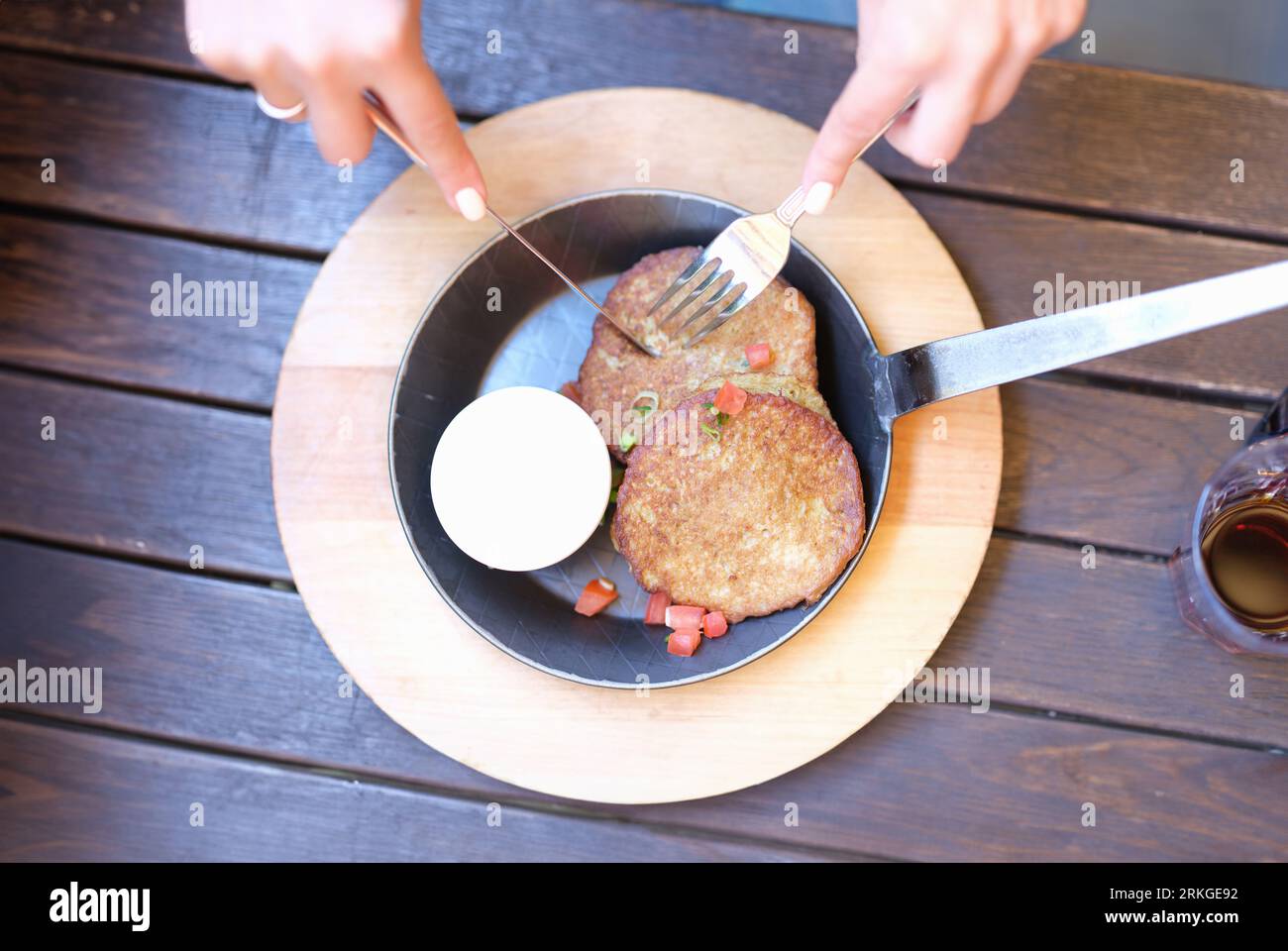 Woman eating potato pancakes hi-res stock photography and images - Alamy