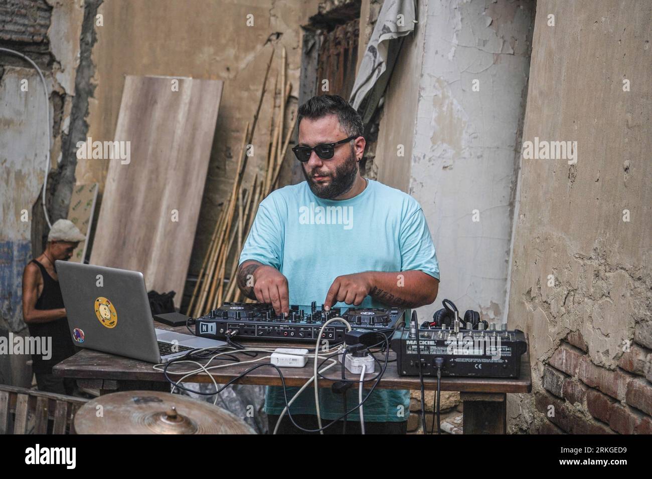 A professional DJ playing music at an outdoor event in the historic ...