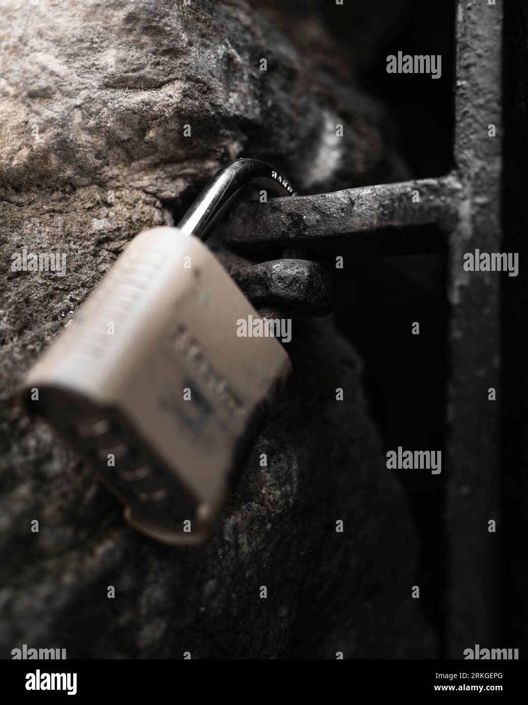 An old steel fence with a padlock secured in place to protect a secure ...