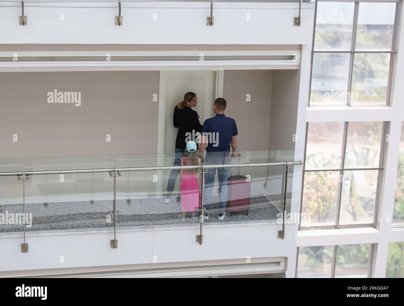 Family parents and child open room at hotel upon check-in Stock Photo ...
