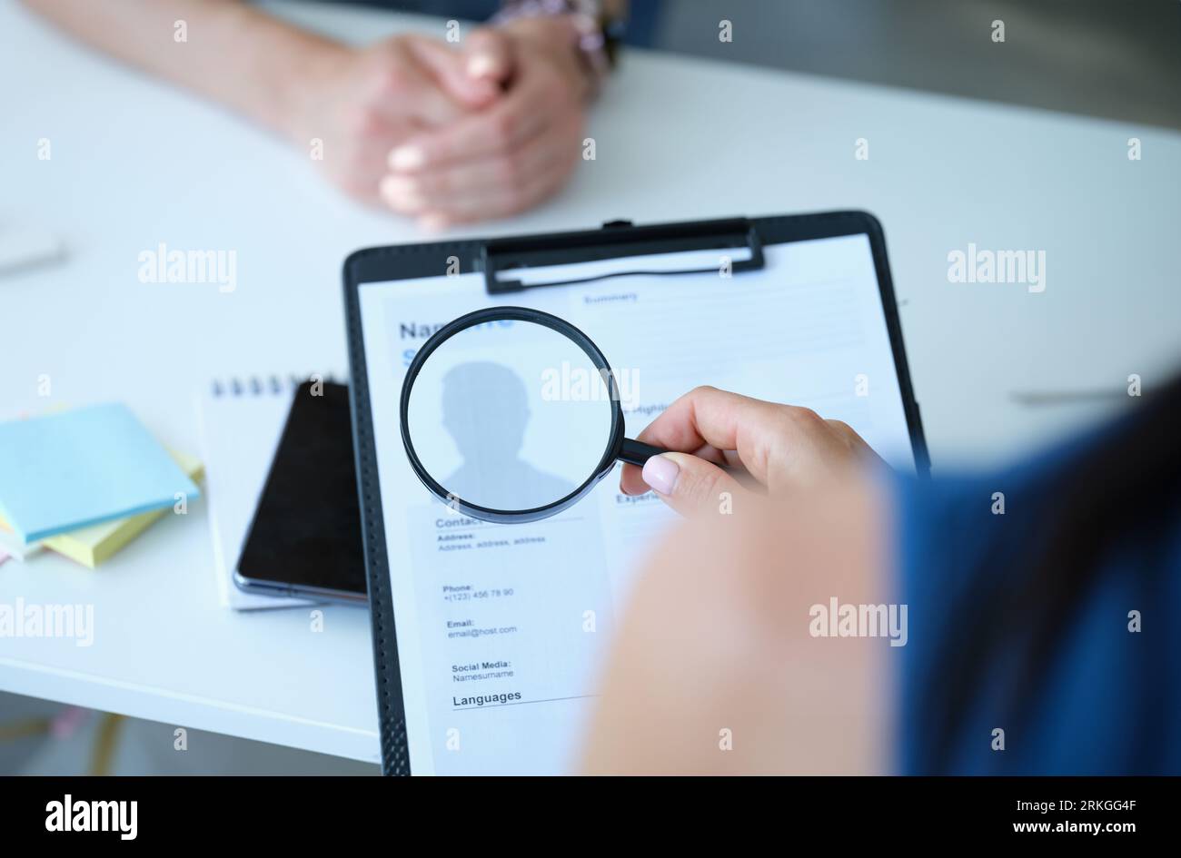 Employee examines resume application form under magnifying glass Stock ...