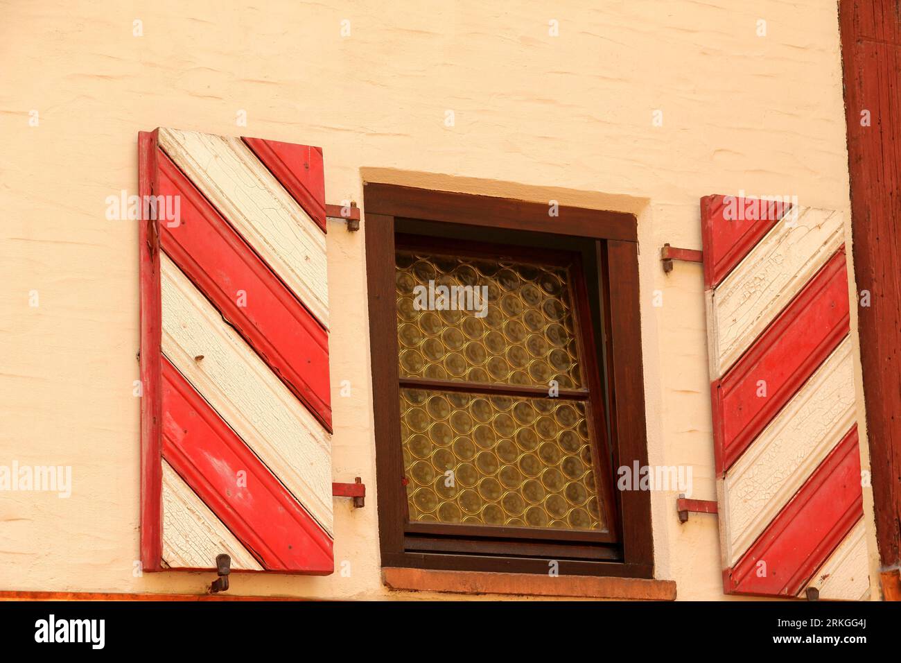 An old building with a red and white striped window is pictured Stock ...