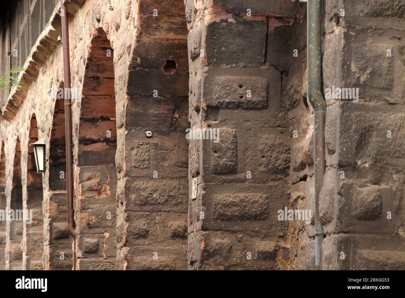 This traditional stone building features an old brick wall with classic ...