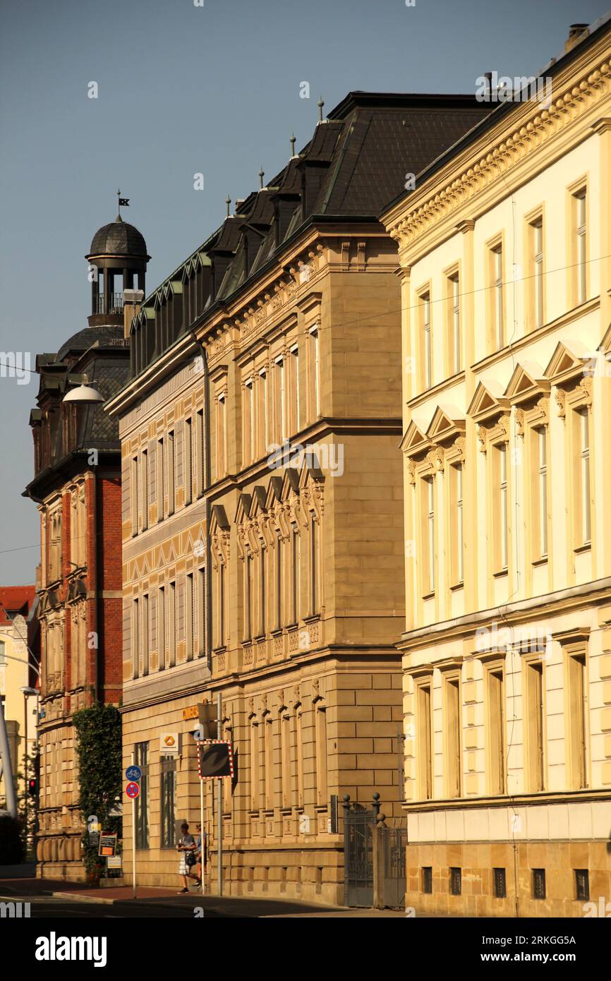 A view of a street with tall buildings flanking either side Stock Photo ...