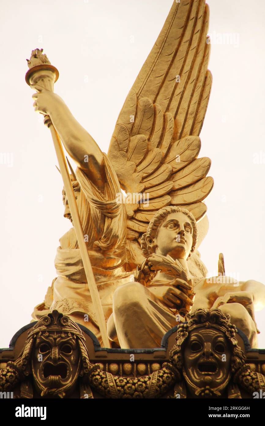 A majestic marble statue perched atop a tall, ornately-engraved column ...