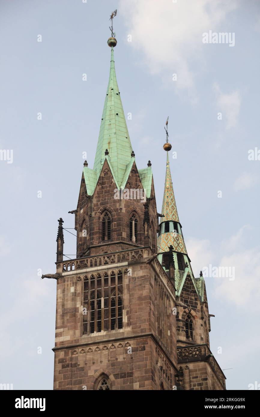 An ancient structure with a vibrant green spire reaching towards the ...