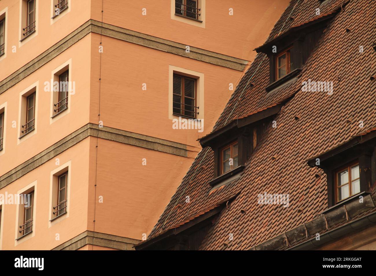An image of a clock tower situated in a city skyline with many windows ...