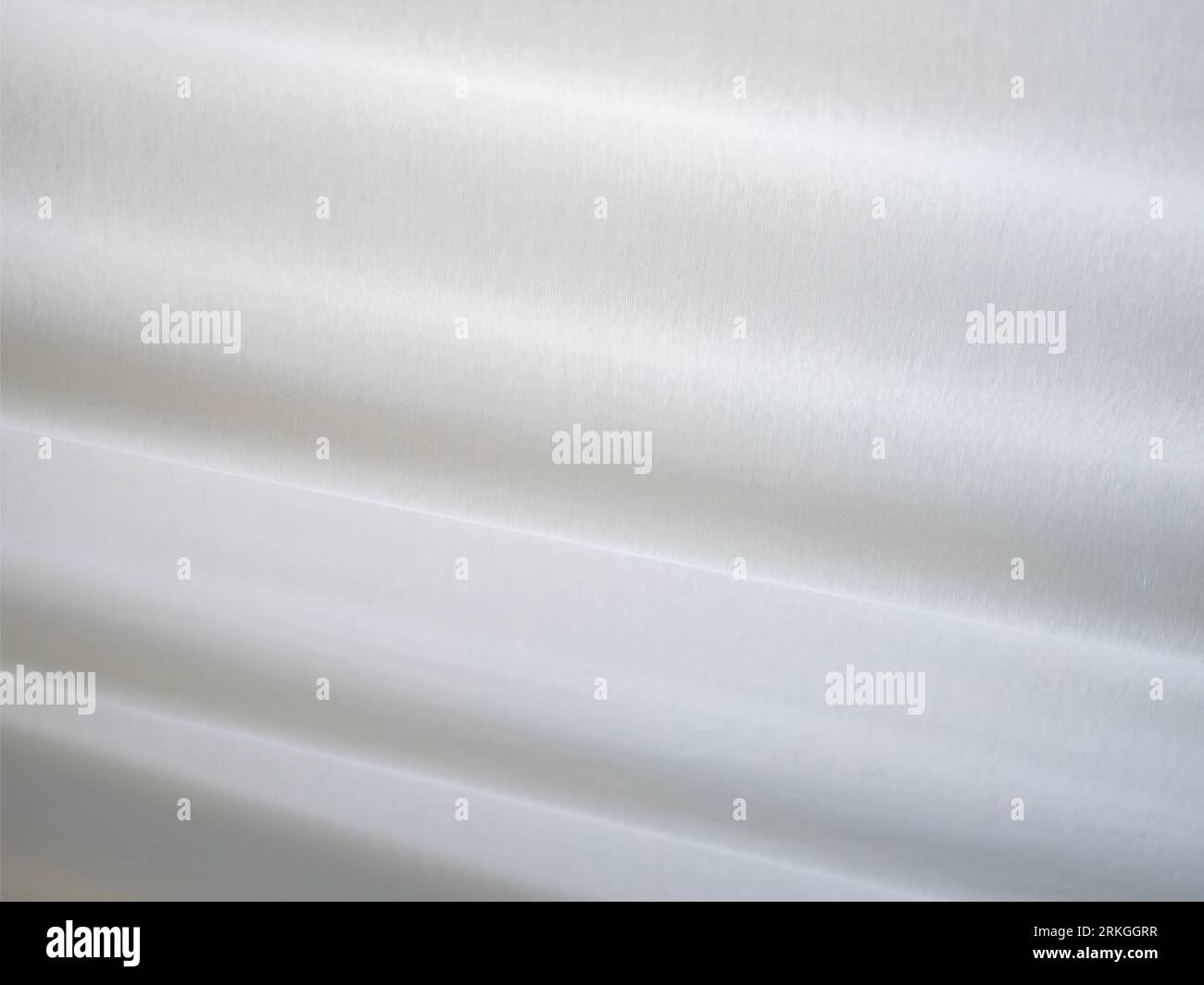 A close-up shot of white plain cloth with subtle, light-colored linear ...