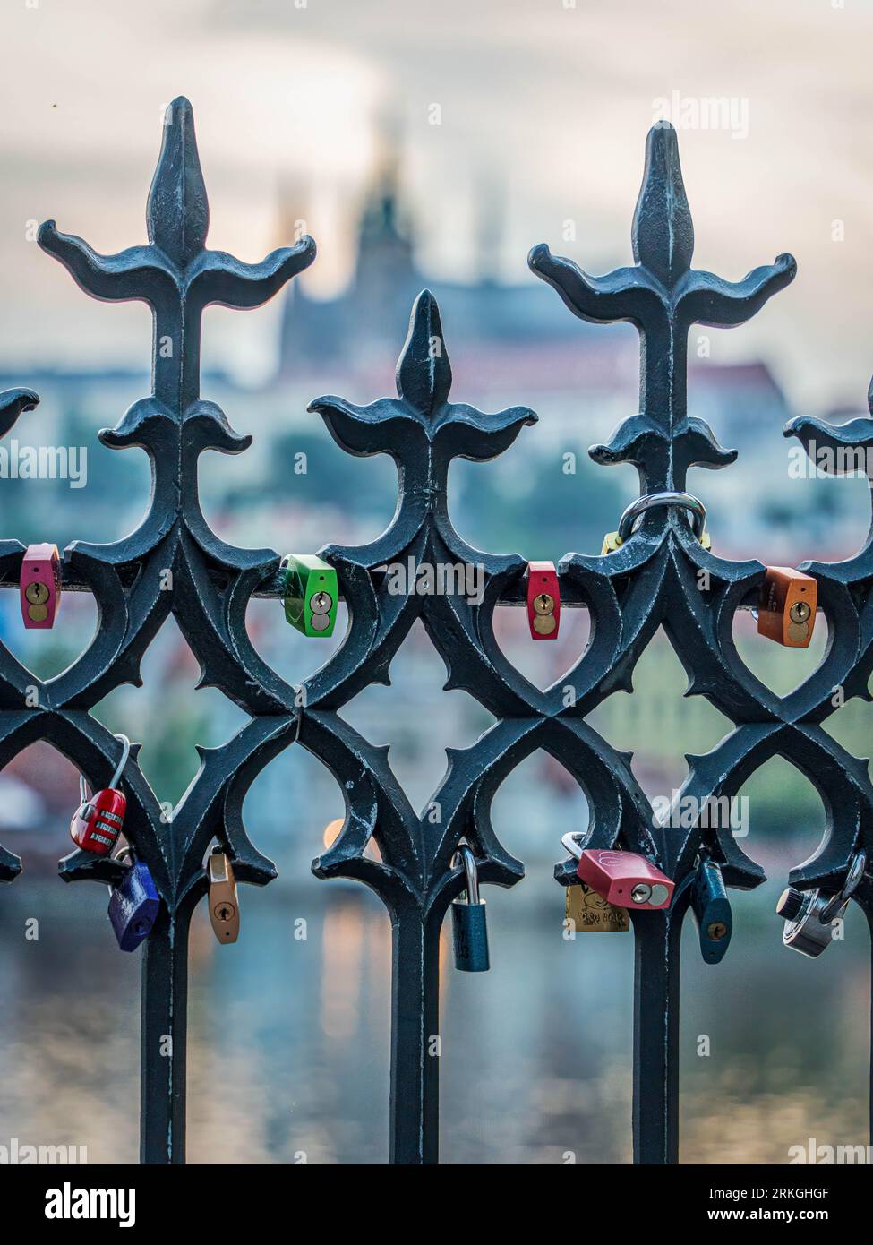 A vertical closeup of colorful padlock on an iron gate in Prague ...
