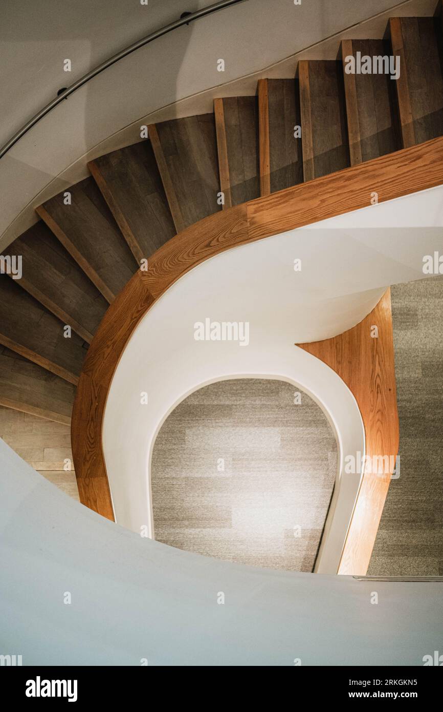 A winding wooden staircase inside a building Stock Photo - Alamy