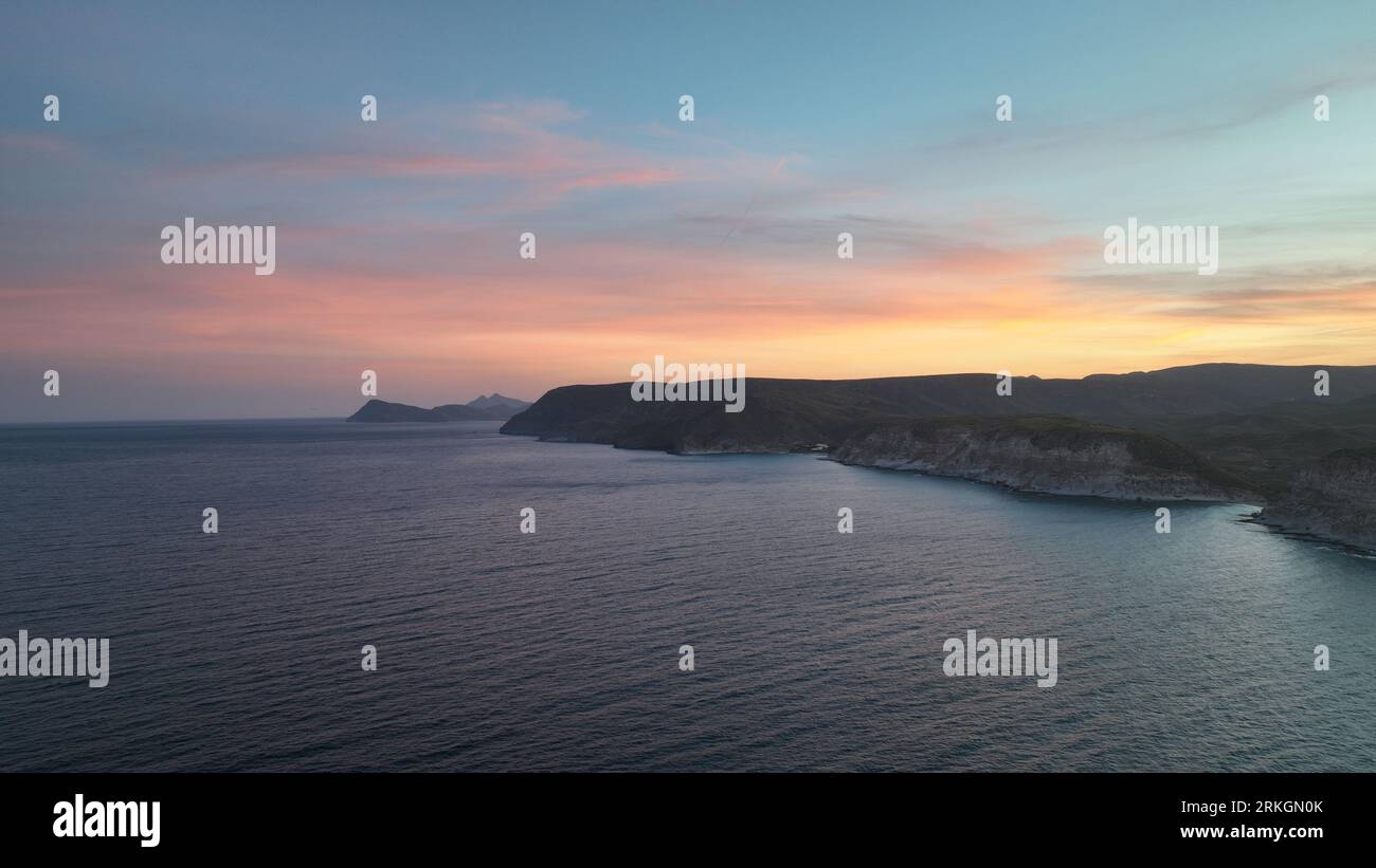 An aerial view of cliffs overlooking the ocean at sunset Stock Photo ...