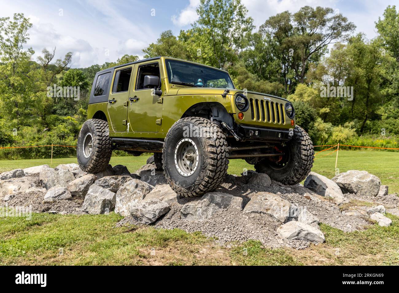An olive green Jeep parked in a scenic outdoor location surrounded by ...