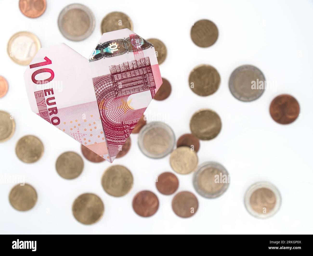A closeup of a heart of a ten euro bill folded, with a white background ...
