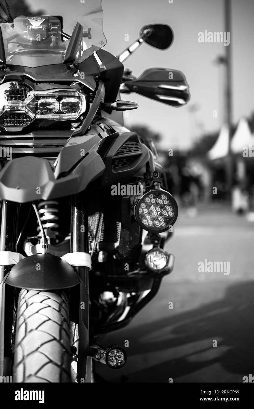 A grayscale of a BMW R1250 GS in the street with a blurry background ...