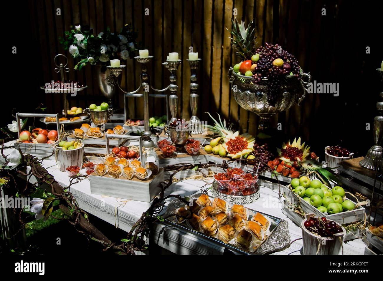 A colorful buffet spread featuring a variety of fruit, desserts, and ...