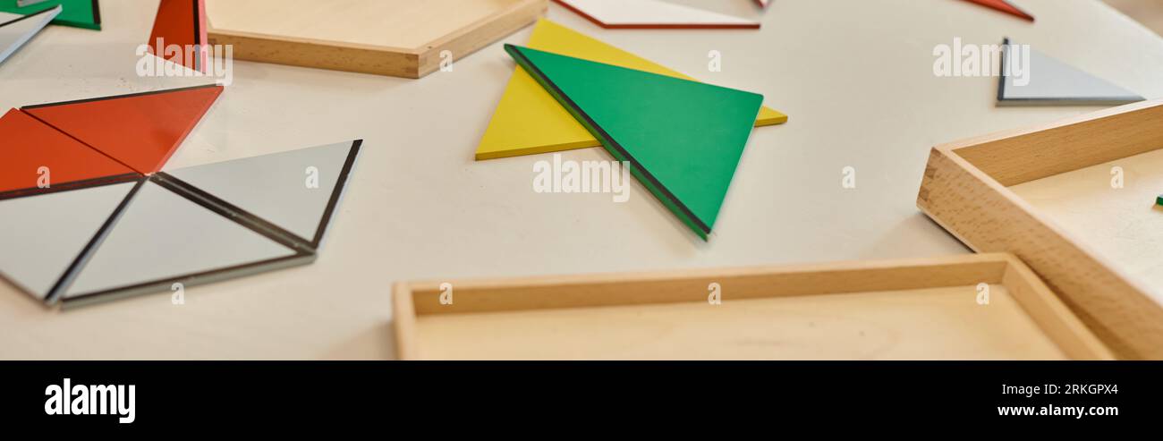 colorful triangles on table in class of montessori school, banner Stock ...