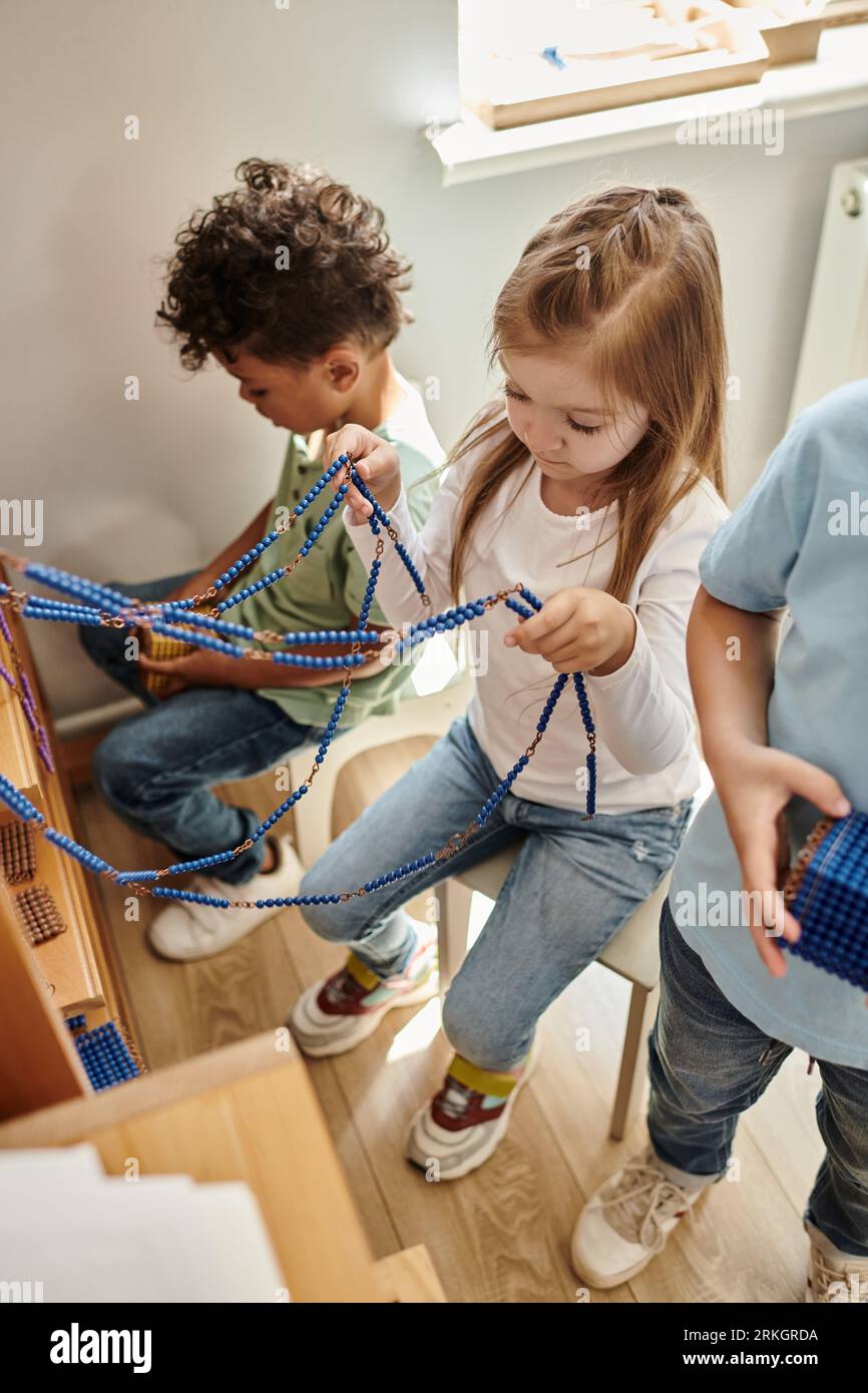smart girl playing with Montessori pearl beads material, learn math ...