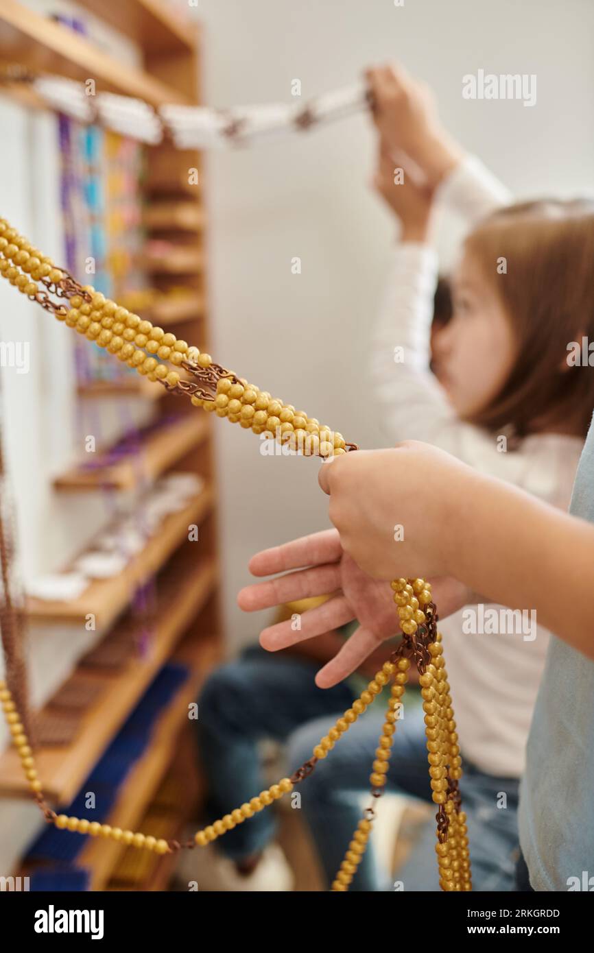 kid counting yellow beads, Montessori school concept, childhood ...