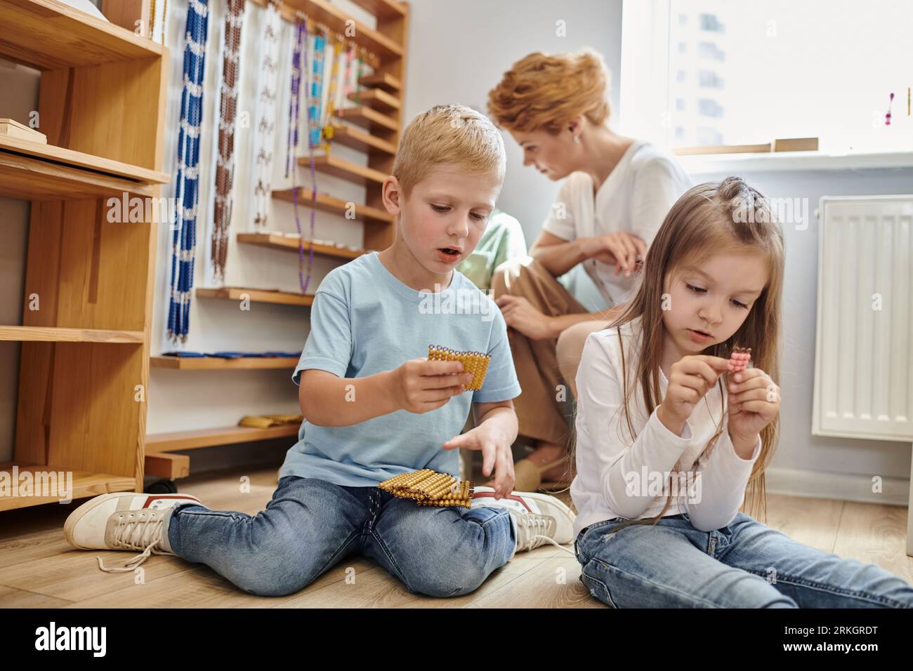 girl and boy holding Montessori beads material, counting, learning ...