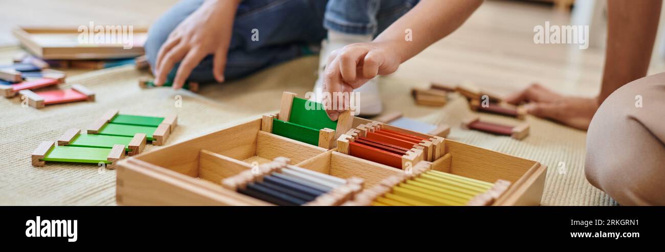 montessori school concept, cropped view of girl playing color matching ...