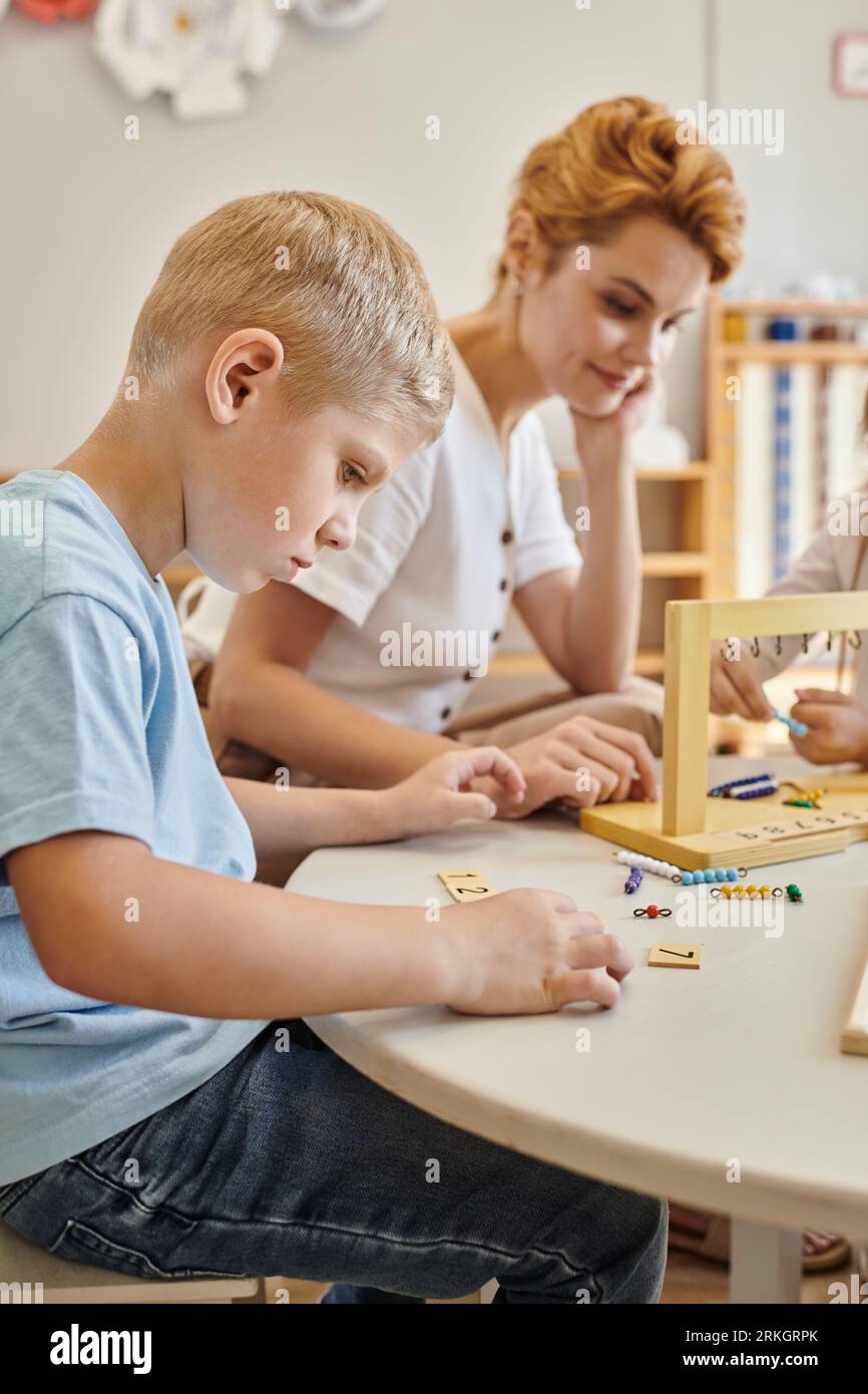 montessori school, kids playing educational game, math learning, boy ...