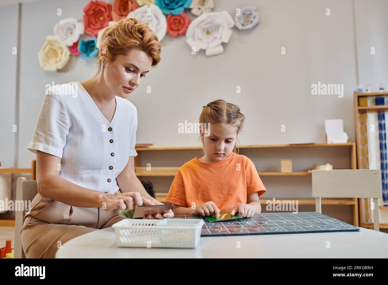 smart girl counting near female teacher, chalkboard, learning how to ...