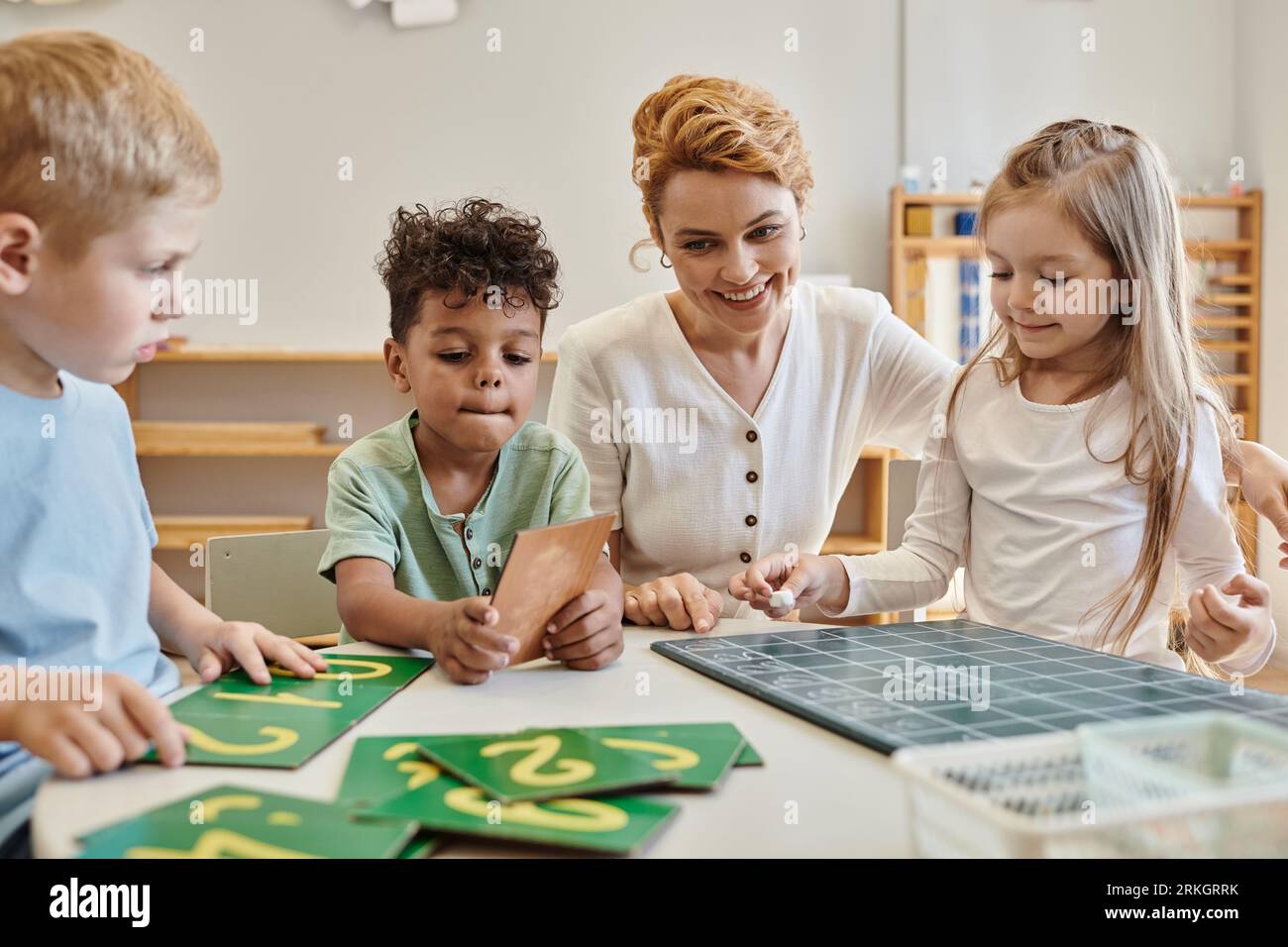 happy interracial kids learning how to count near numbers and female ...