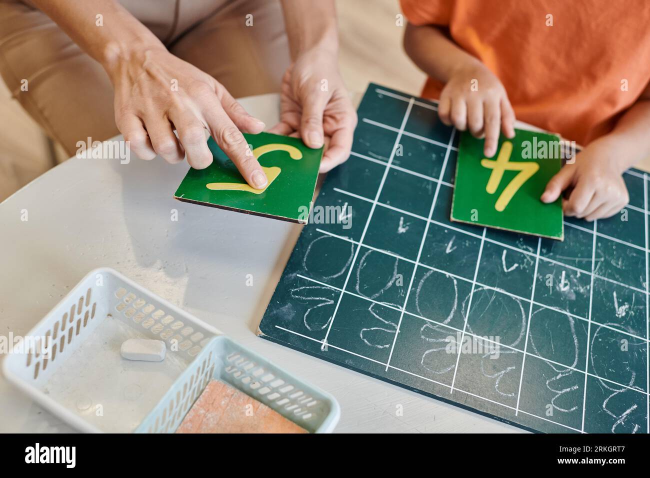 smart girl counting near teacher, chalkboard, learning how to count in ...
