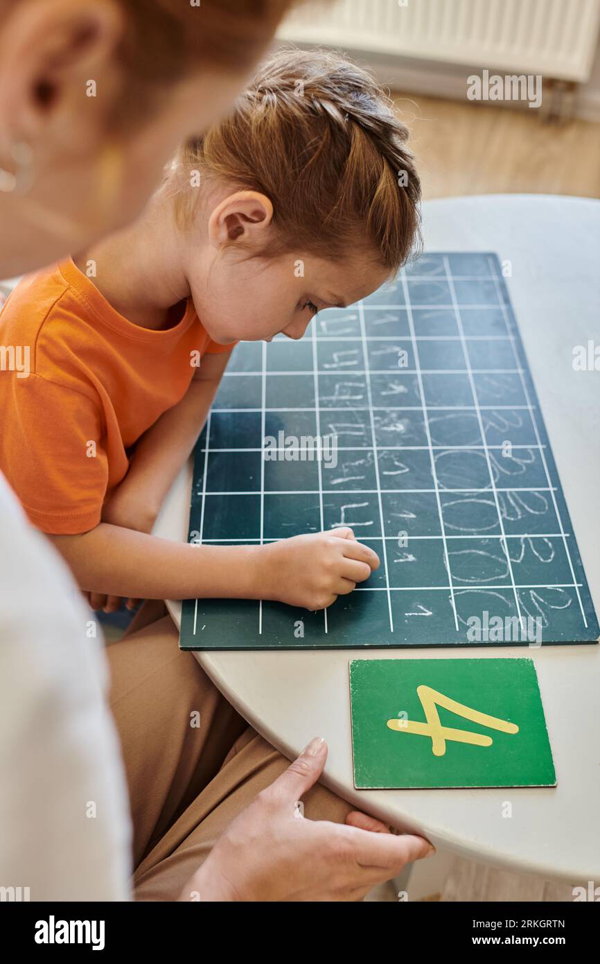 female teacher observing smart girl in Montessori school, counting ...