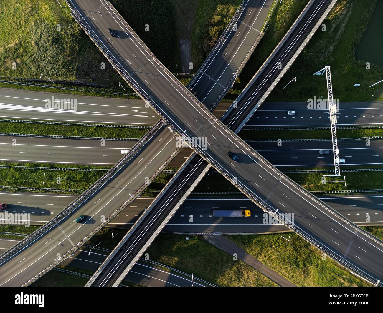 An aerial view of a highway with numerous roads and vehicles navigating ...