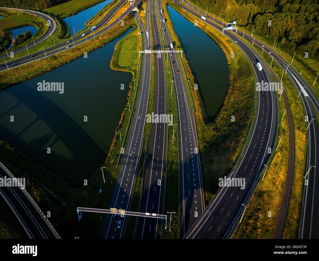An aerial view of a highway with a river running in the background ...