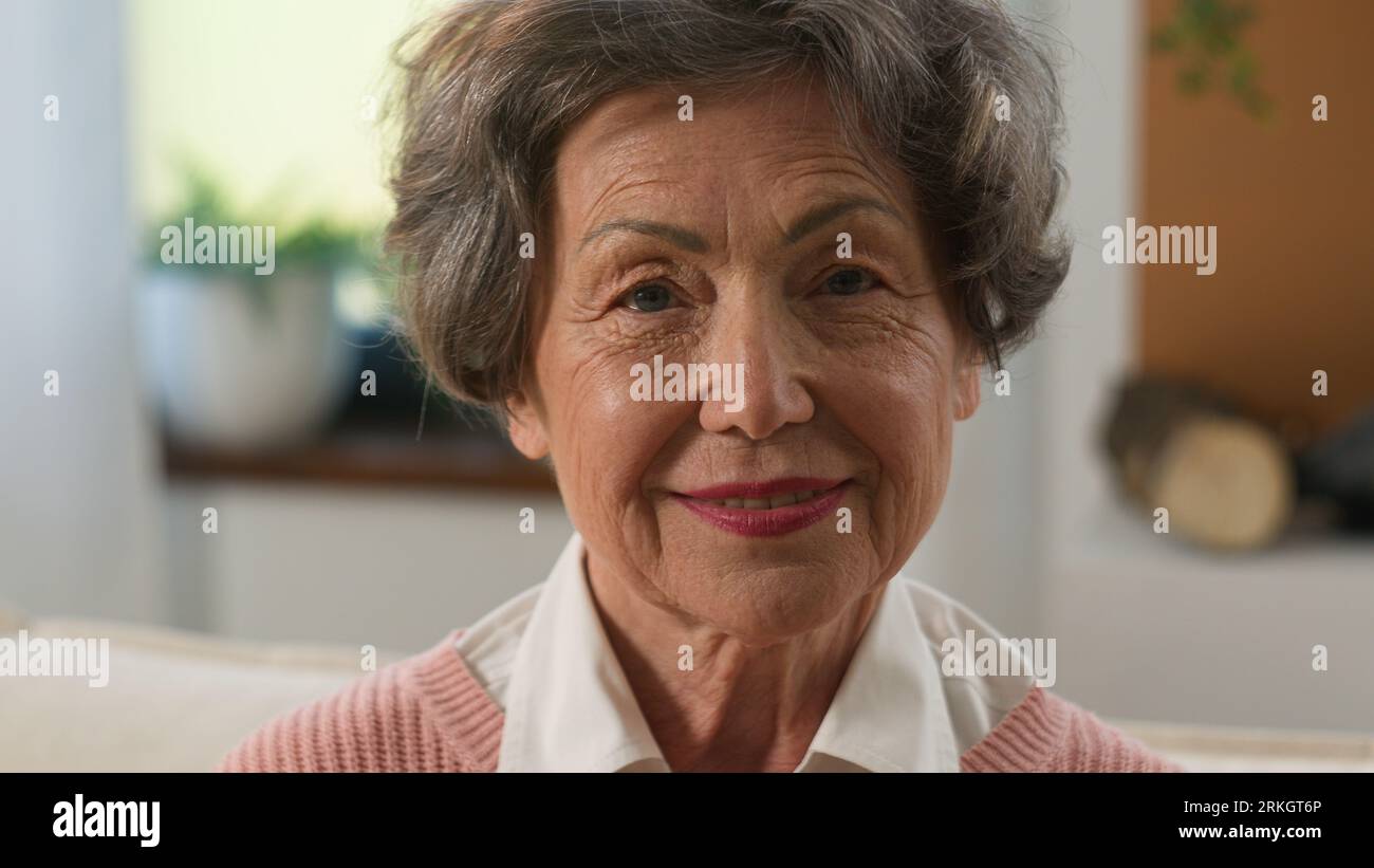 Headshot pensive grandmother senior woman looking distance away turn to ...
