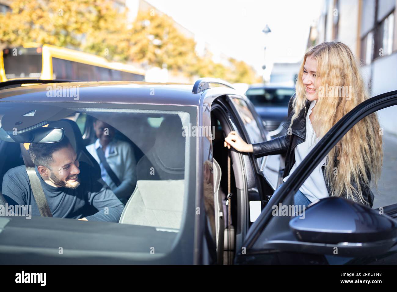 Happy Blonde Women Sitting Inside Car With Her Friends Stock Photo - Alamy