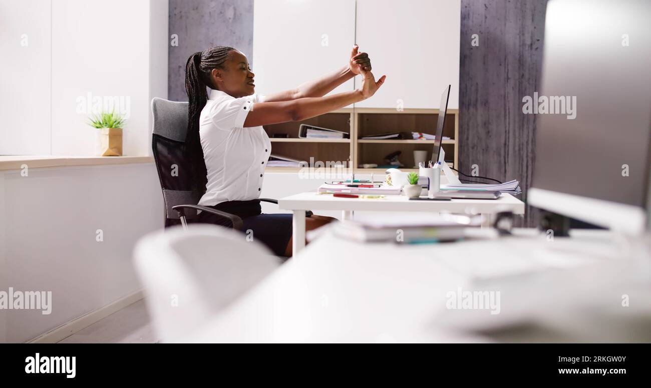 Stretch Exercise At Office Desk Near Computer Stock Photo - Alamy