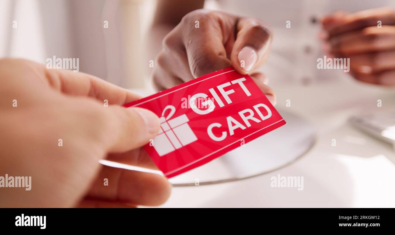 Holding Giving Gift Card Voucher And Ticket Stock Photo - Alamy