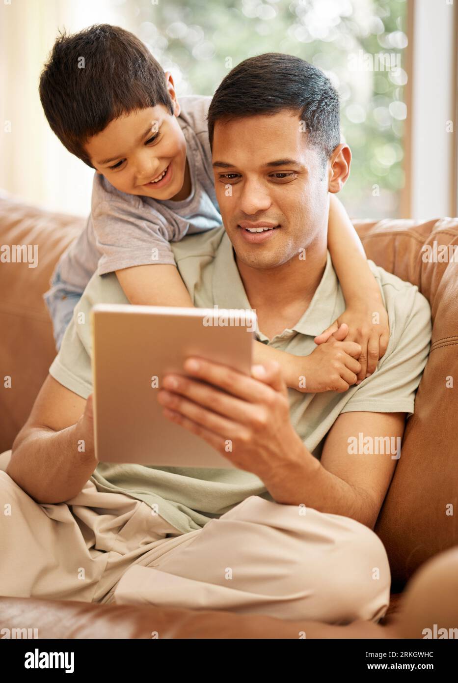 Happy father, kid and hug with tablet in home for online games, reading ...